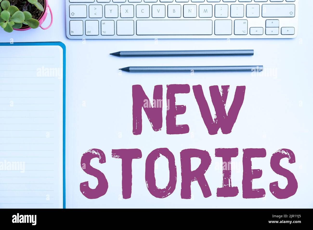 A NEW STORIES conceptual text on white background surrounded with ...