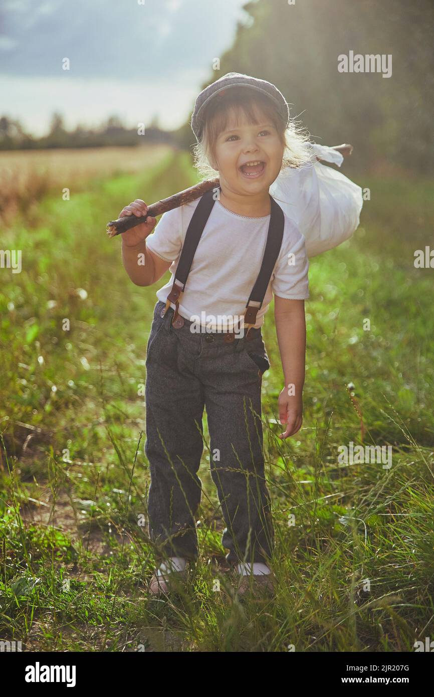 Adorable street child in a field at sunset Stock Photo - Alamy