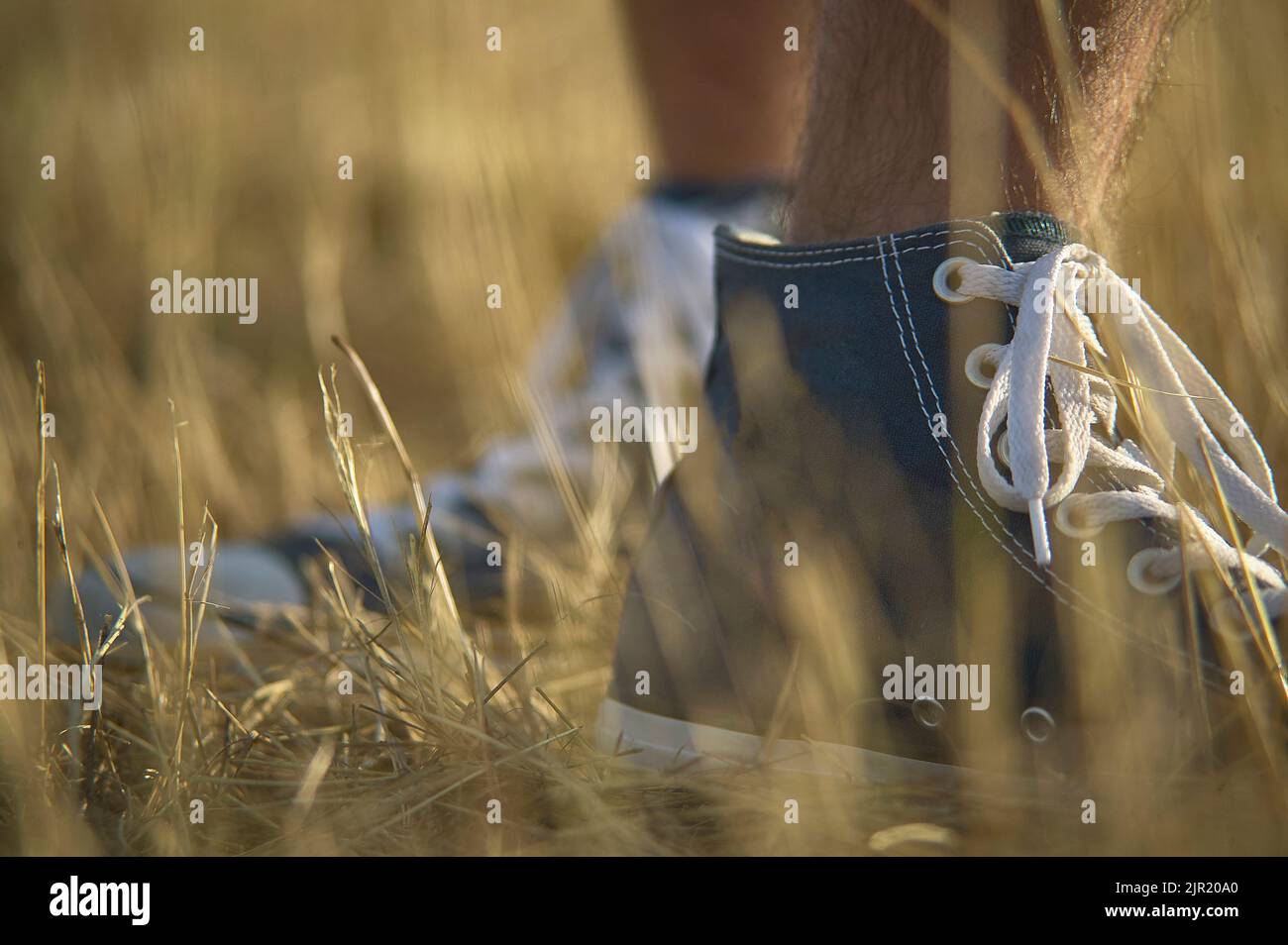 Shoe in the foreground with behind the other while being worn by a boy ...