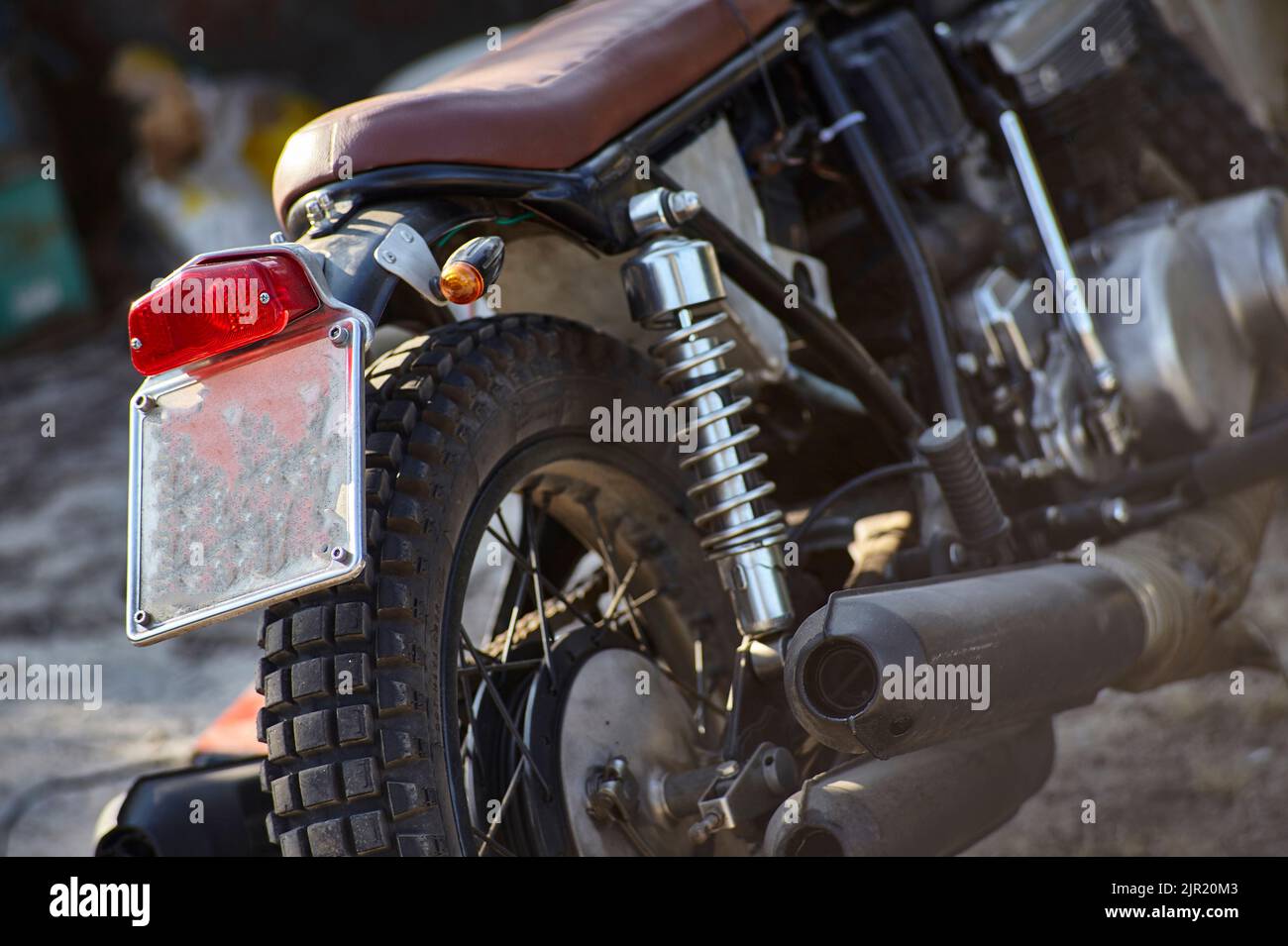Back of a vintage motorcycle with the red light in the middle and other ...