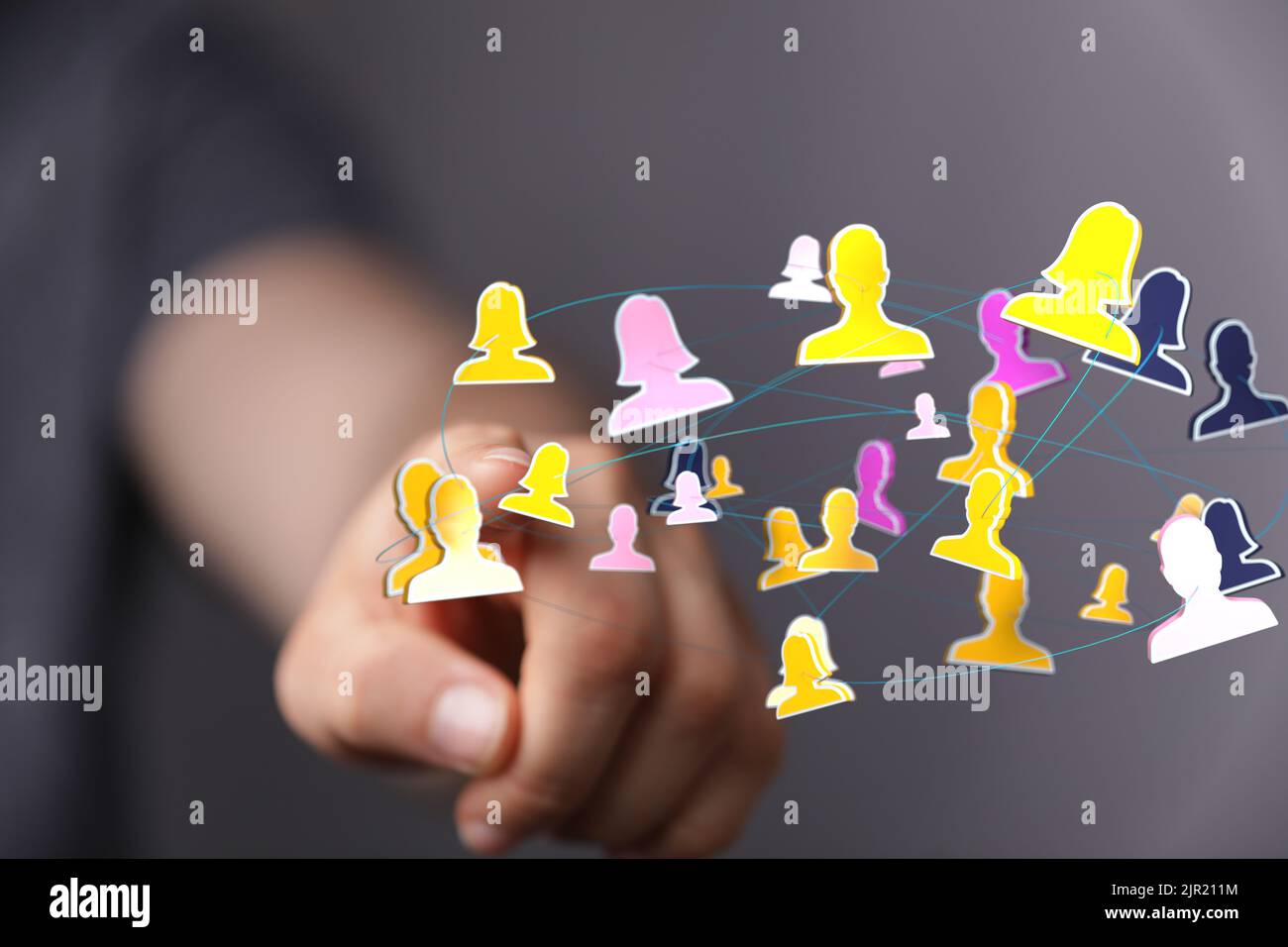 A finger touching a 3d rendering of floating connected profile icons ...