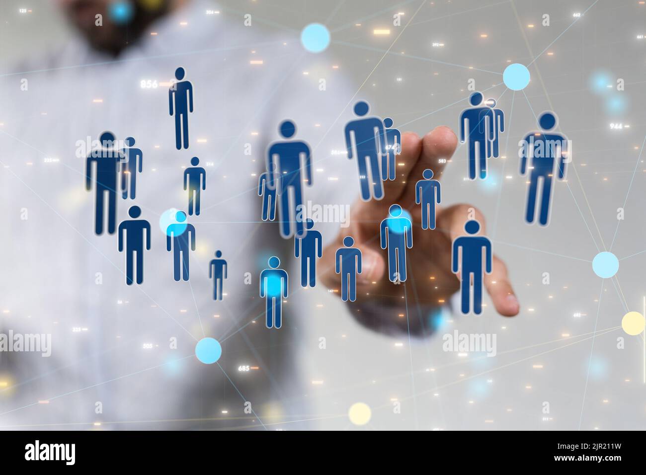 A finger touching a 3d rendering of floating connected profile icons ...