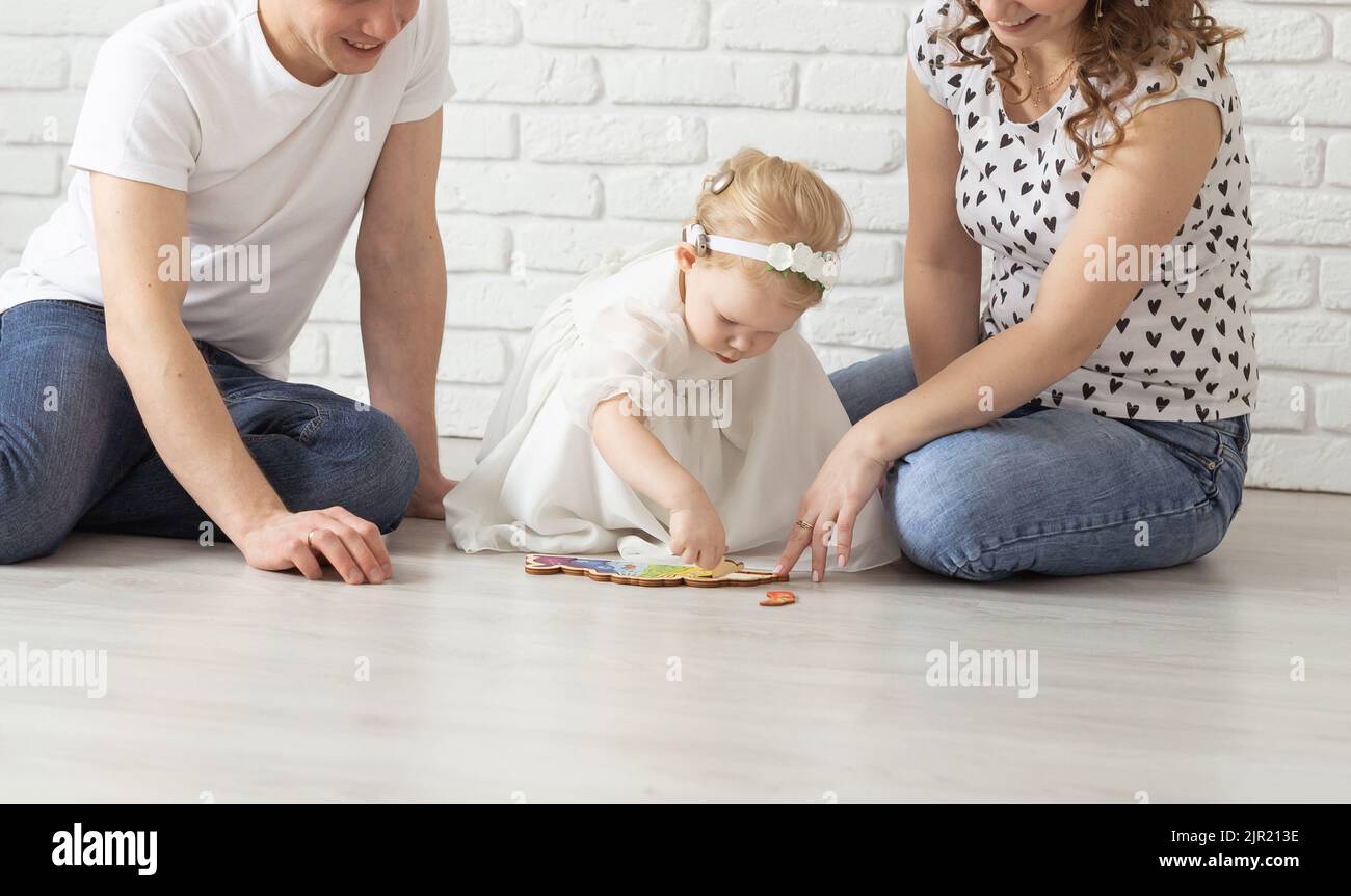 Baby child with hearing aids and cochlear implants plays with parents ...