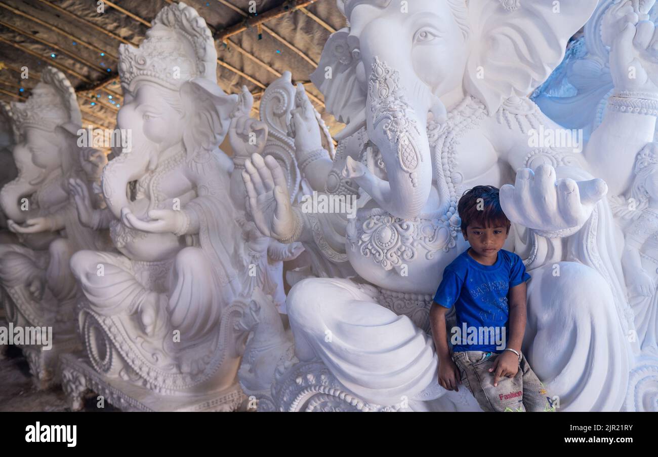 Pileru, India - July 28,2022:Kid sat on the lap of lord ganesha idol ...