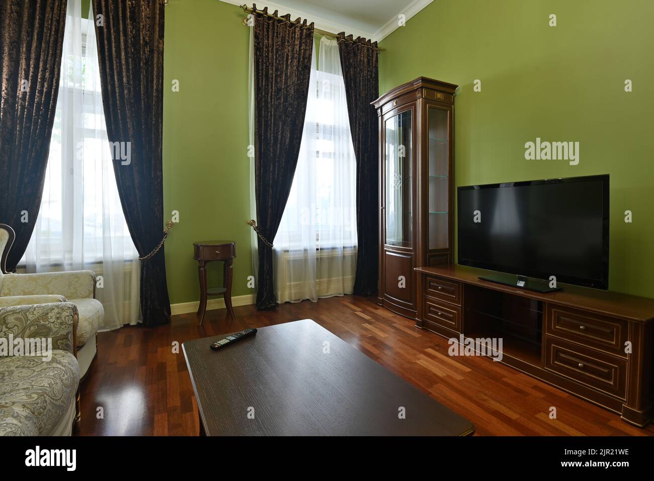 A beautiful hall in a large house with high ceilings, antique furniture ...