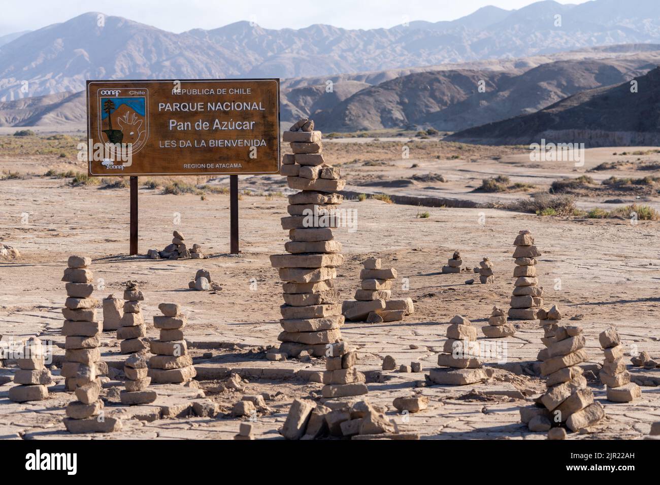 Rock cairns and a sign at the entrance to Pan de Azucar National Park ...