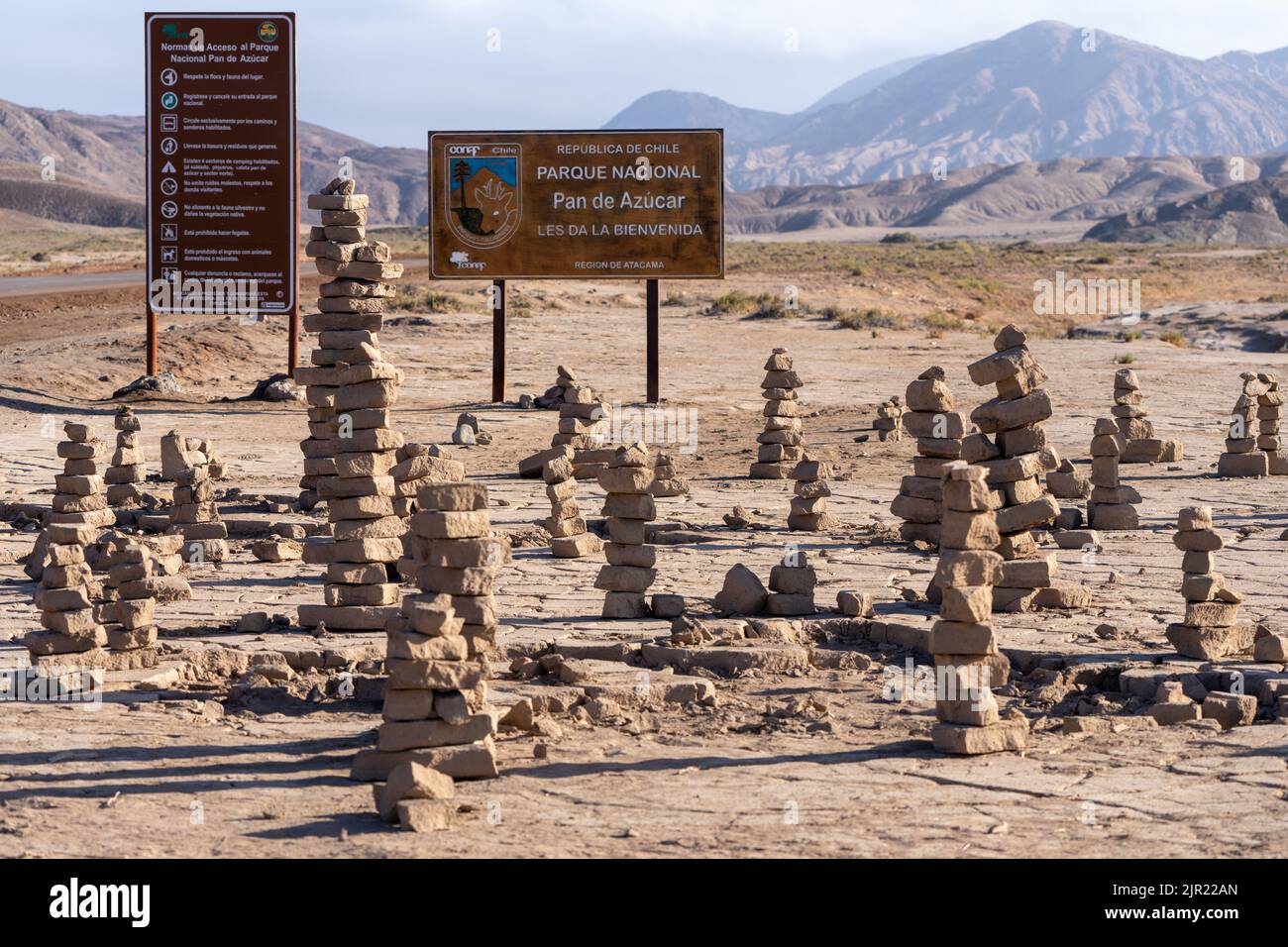 Rock cairns and a sign at the entrance to Pan de Azucar National Park ...