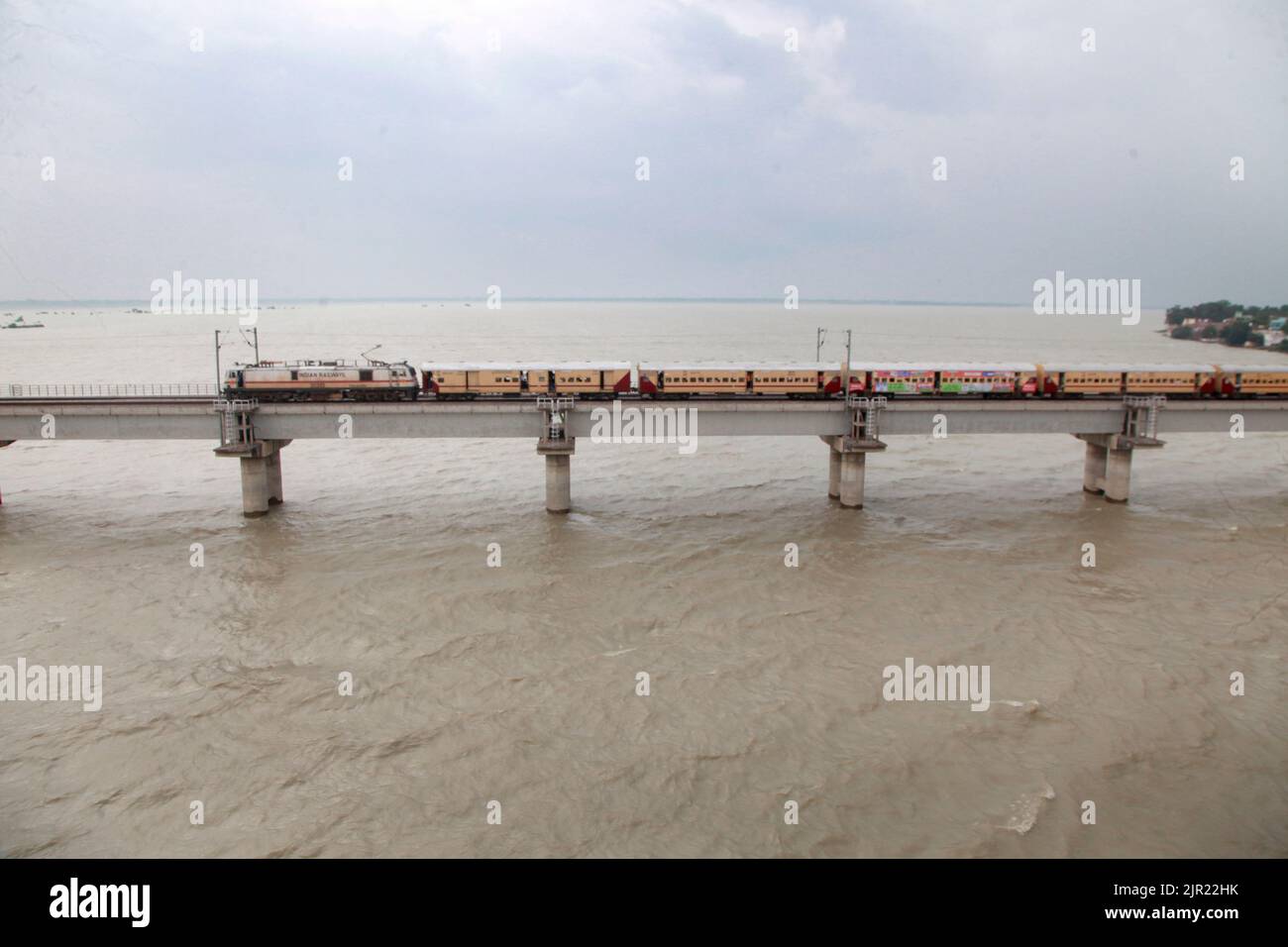 Prayagraj, India. 21/08/2022, A passenger train passes over the bridge ...