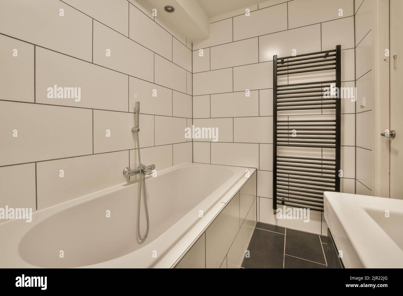 Modern home interior design of white bathroom with open bathtub and ...