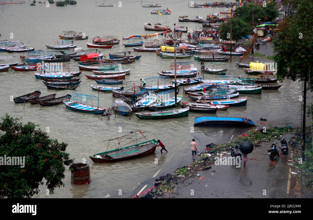 Prayagraj, India. 20/08/2022, A boatman shifts his docked boat at banks ...