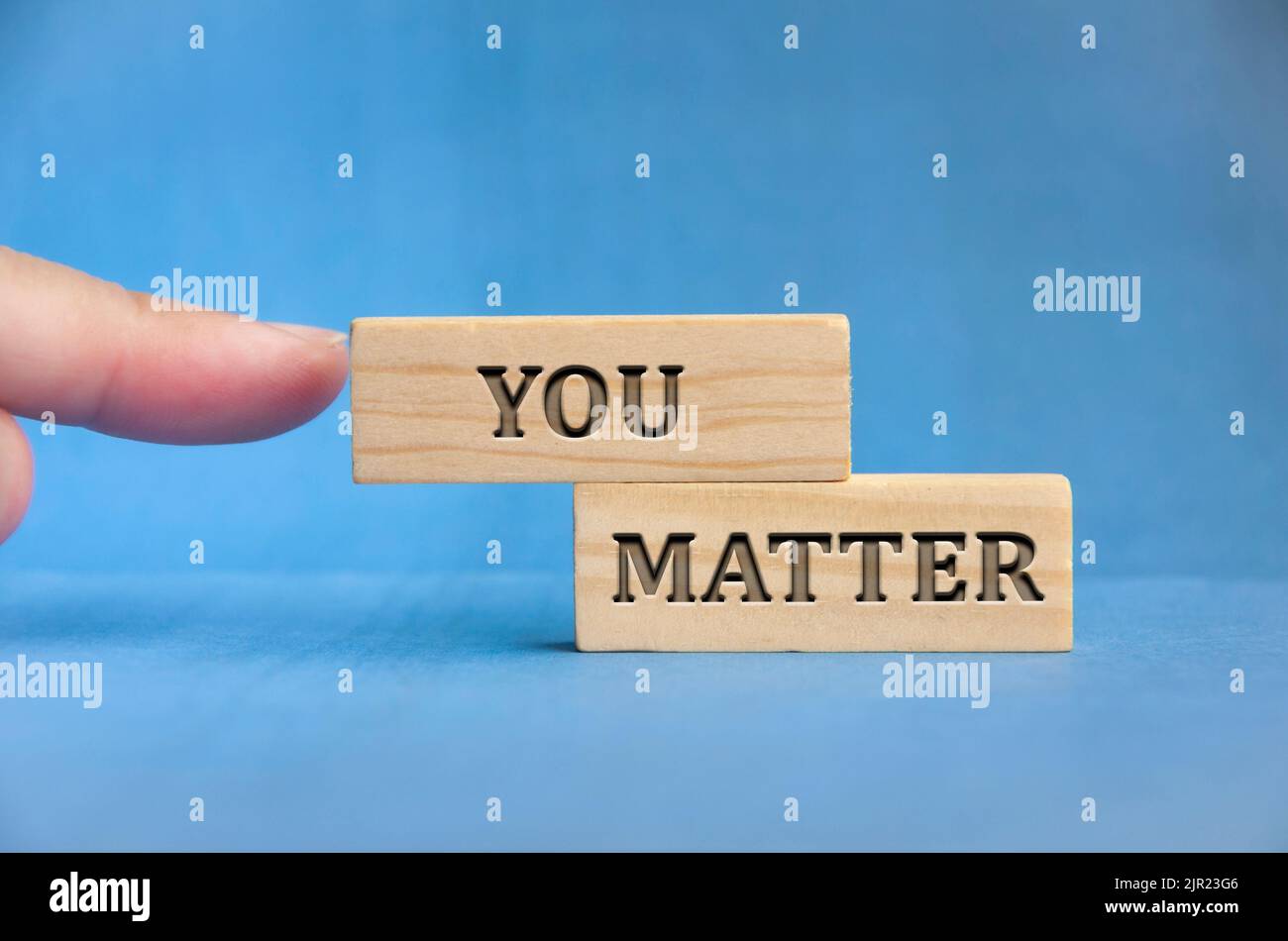 Finger pointing you matter text engraved on wooden block. Inspirational ...
