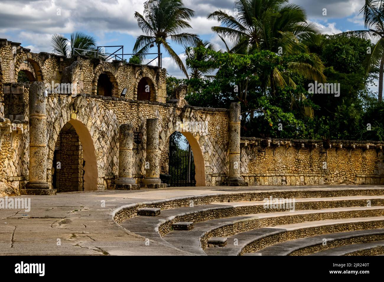 A beautiful stone-made building with palm trees in Altos de Chavon ...