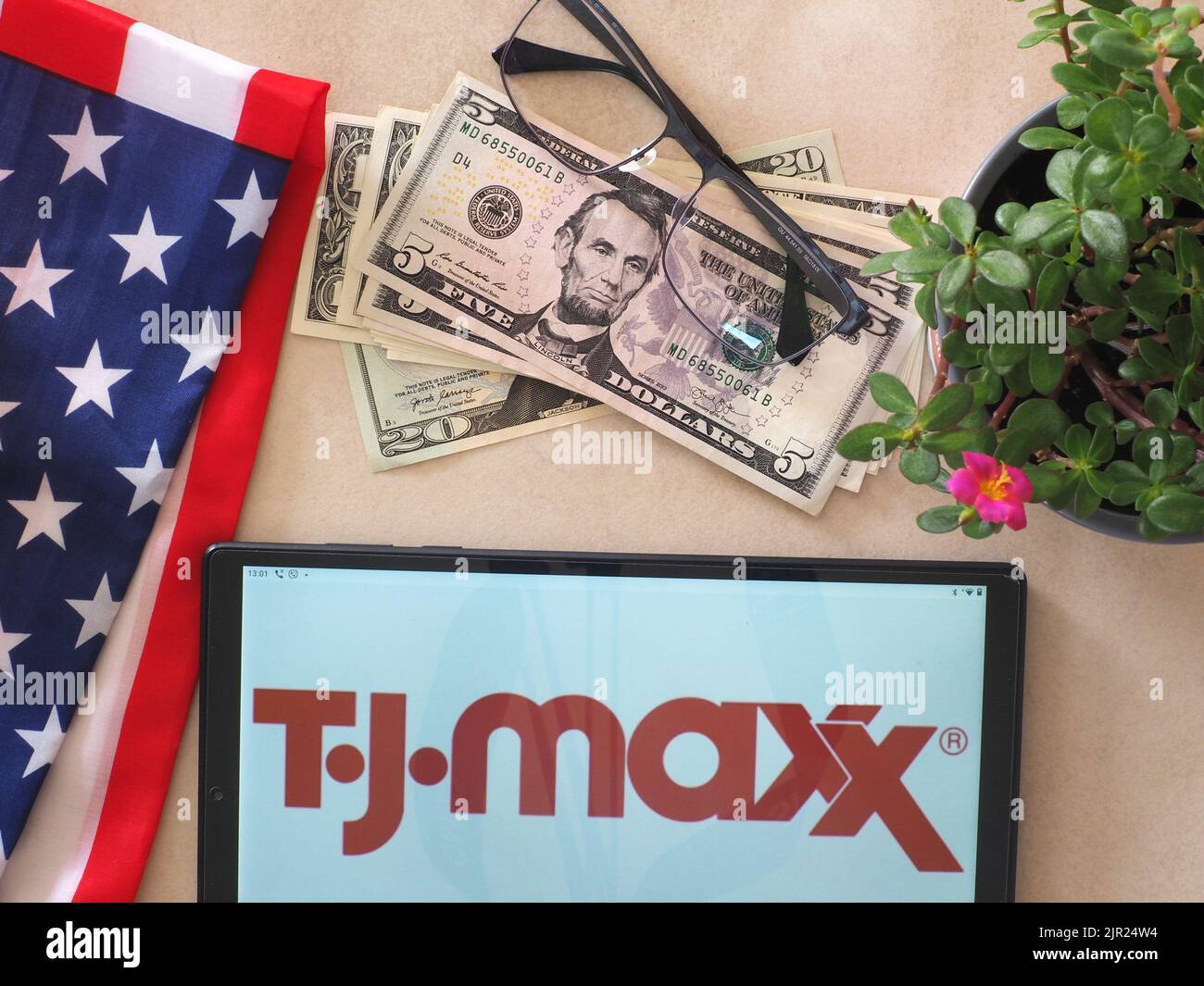 In this photo illustration, a T.J. Maxx logo seen displayed on a tablet ...