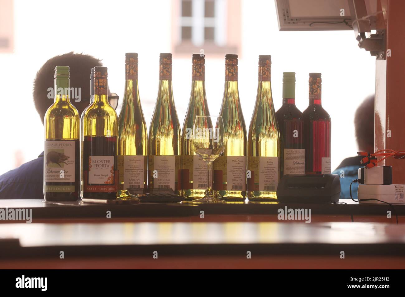 Bad Sulza, Germany. 21st Aug, 2022. Wine bottles stand on a sales cart ...