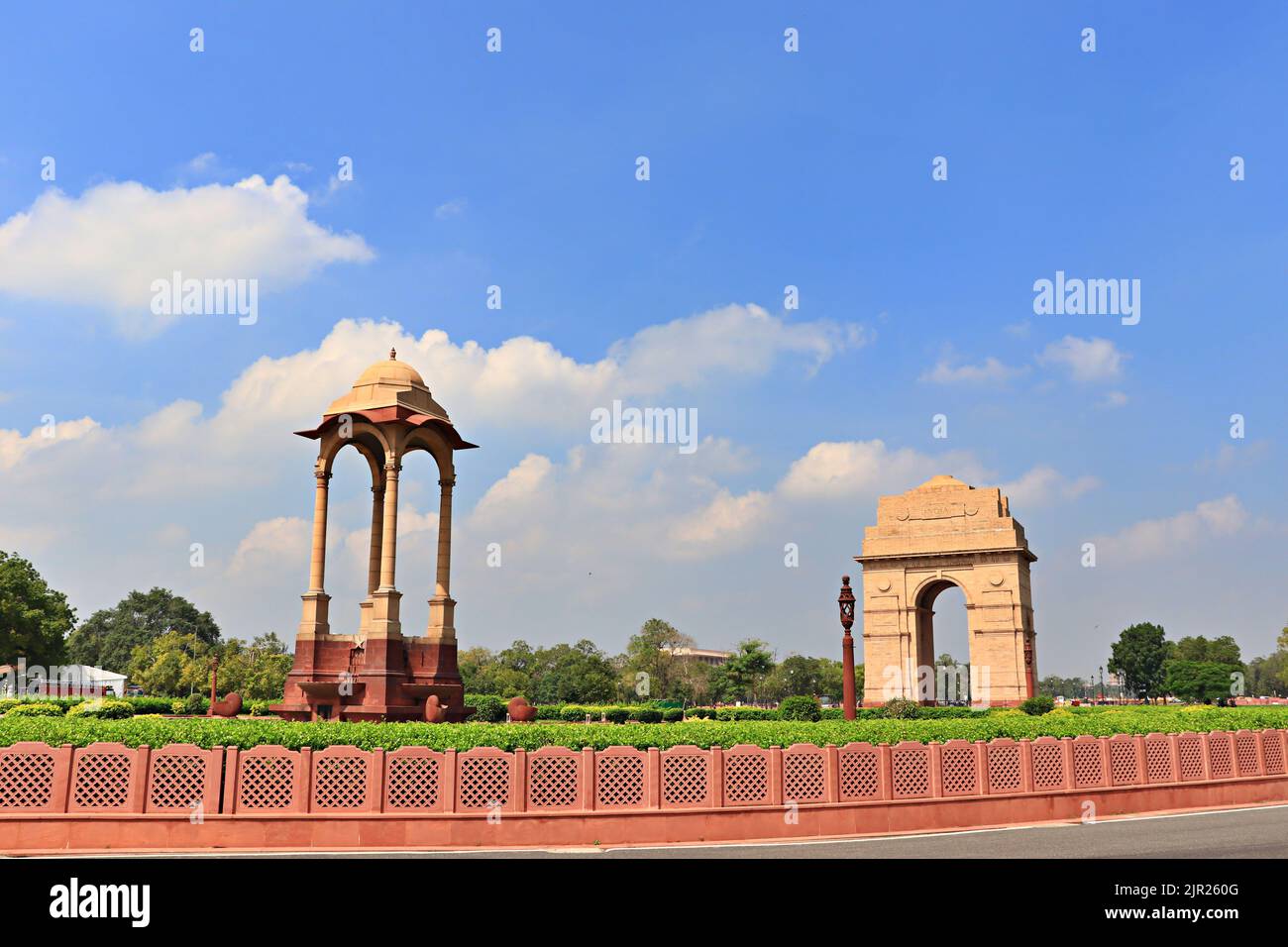 The India Gate and the Canopy against blue sky and clouds/New Delhi ...