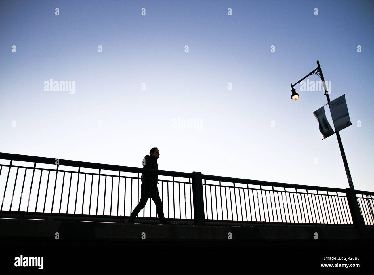 One man running on bridge Stock Photo - Alamy