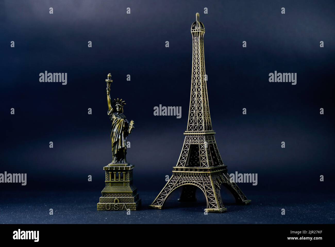 A closeup of metal miniatures of the Eiffel Tower and Statue of Liberty ...