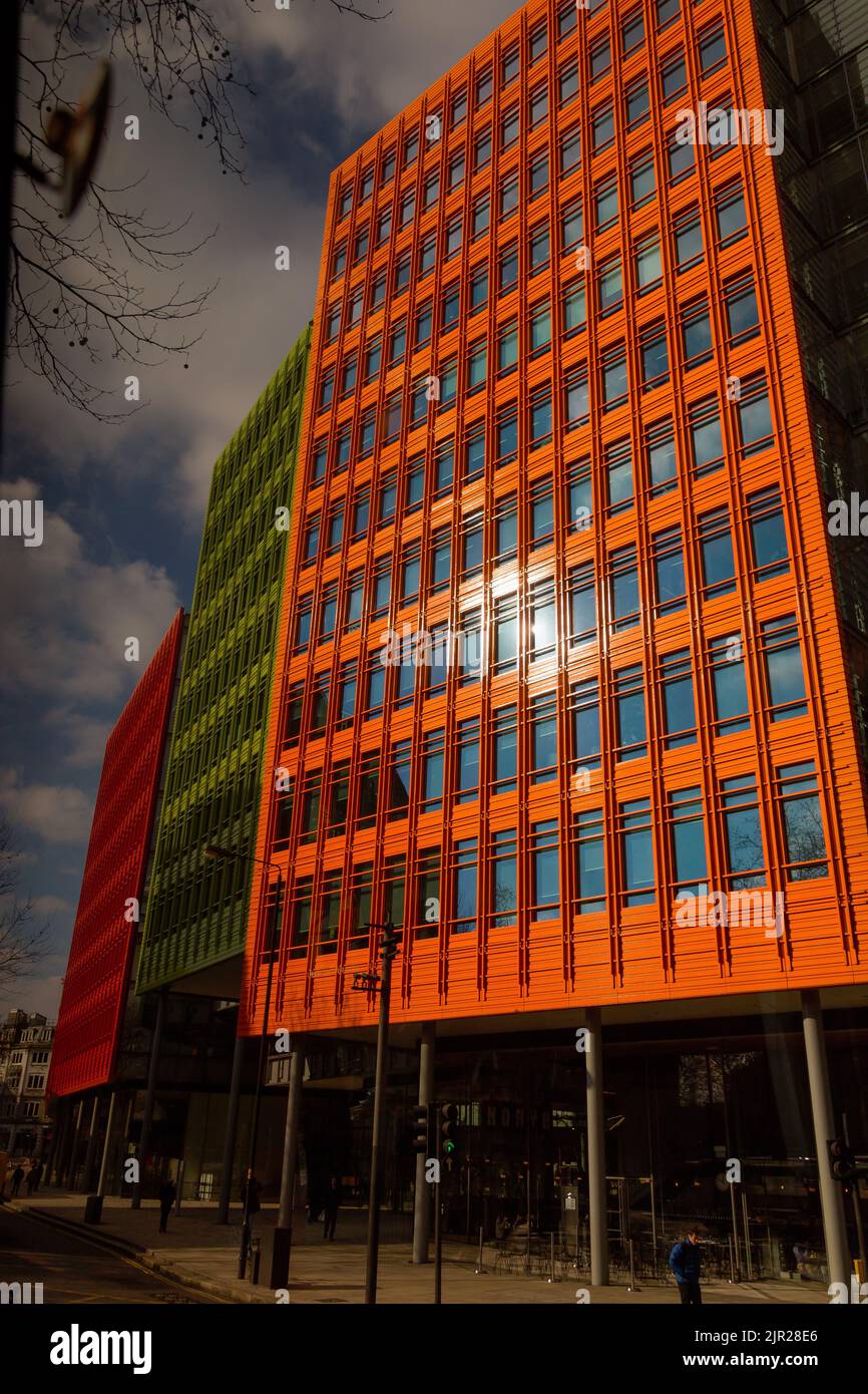 A vertical shot of an orange Central Saint Giles building in London ...