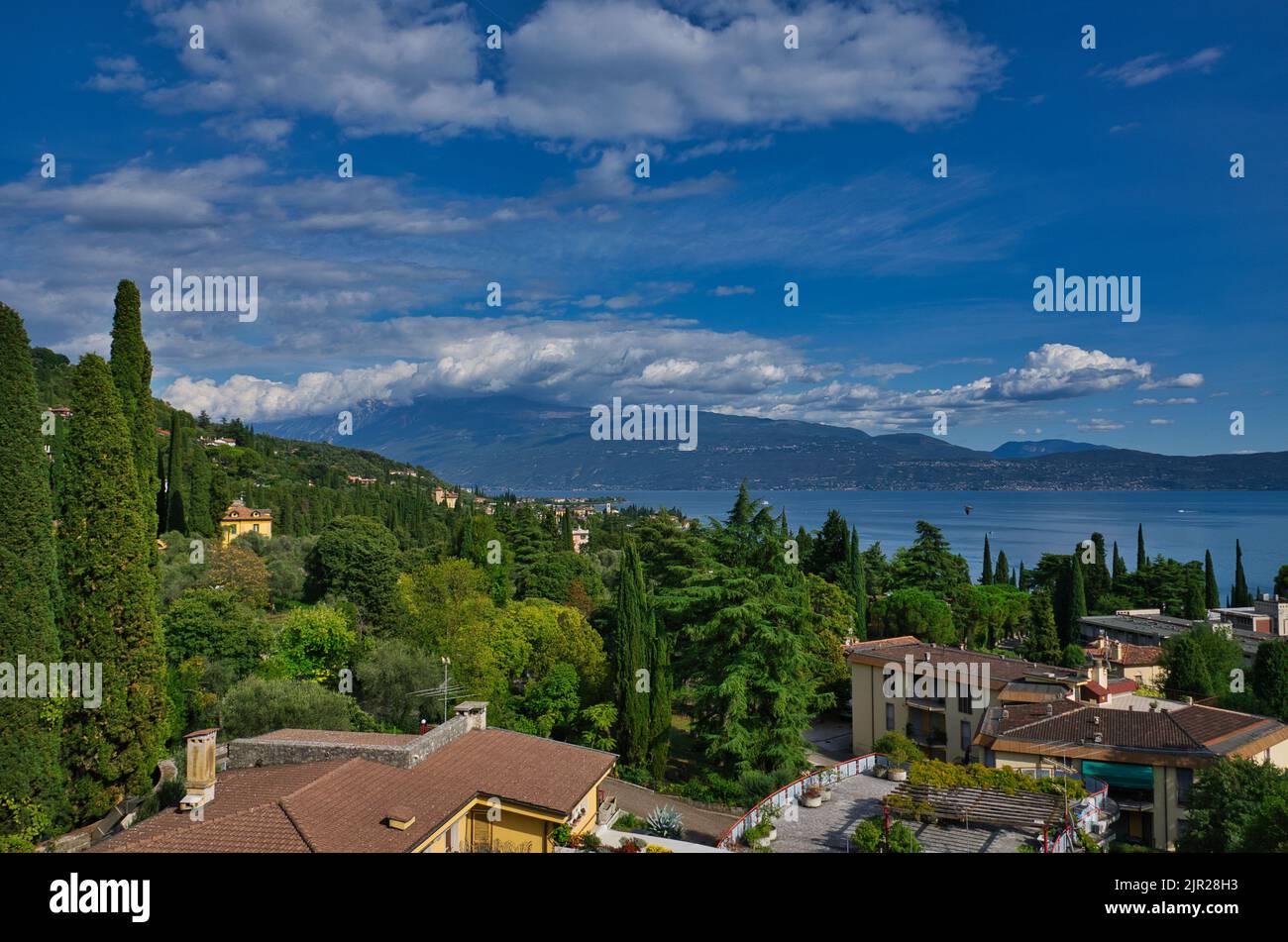 An aerial view of the buildings and trees with a sea in the background ...