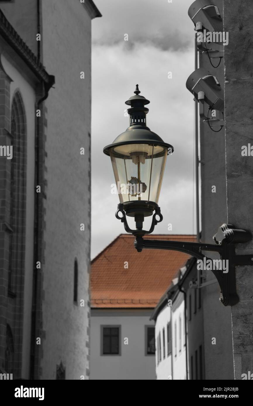 A vertical shot of a Lantern on a building with a cloudy sky background ...