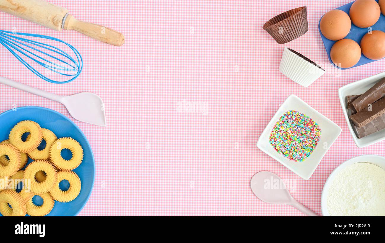 ingredients for preparing cookies on pastel pink background with copy ...