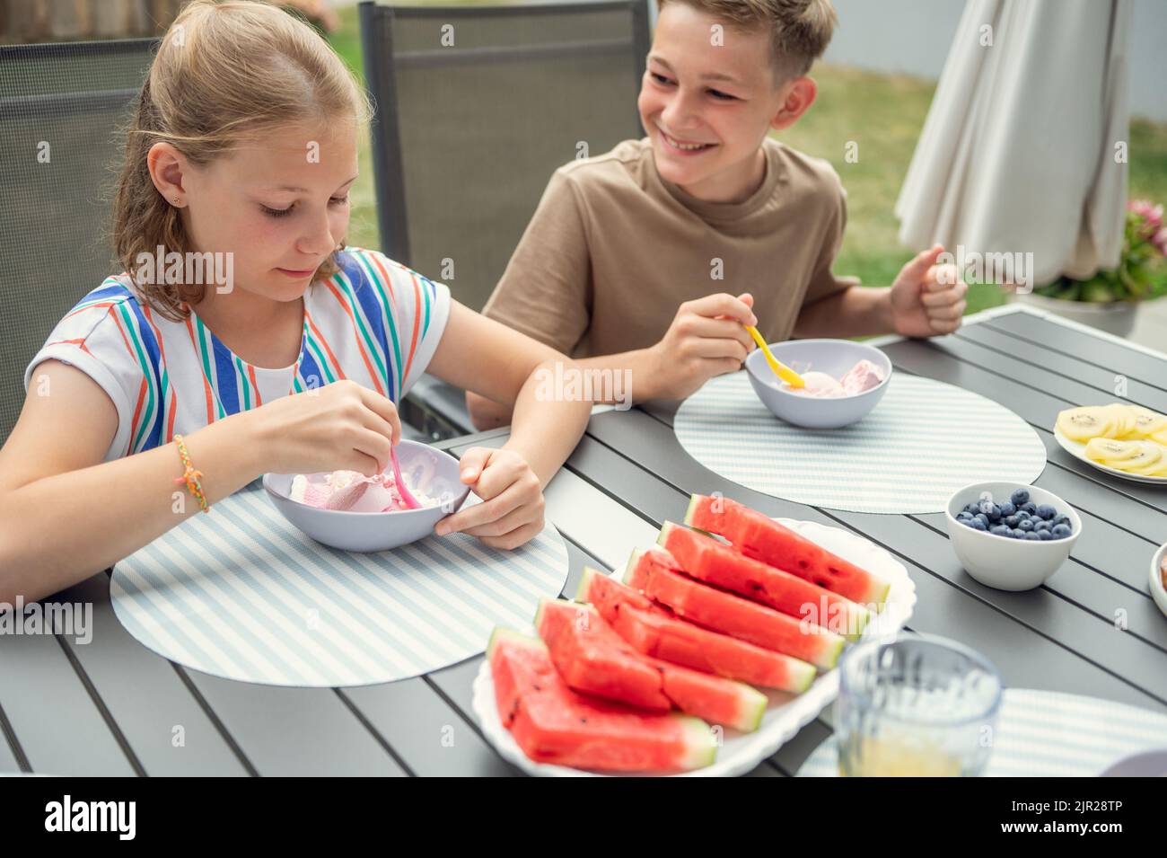 Teen brother and suster having breakfast outdoors in the backyard Stock ...