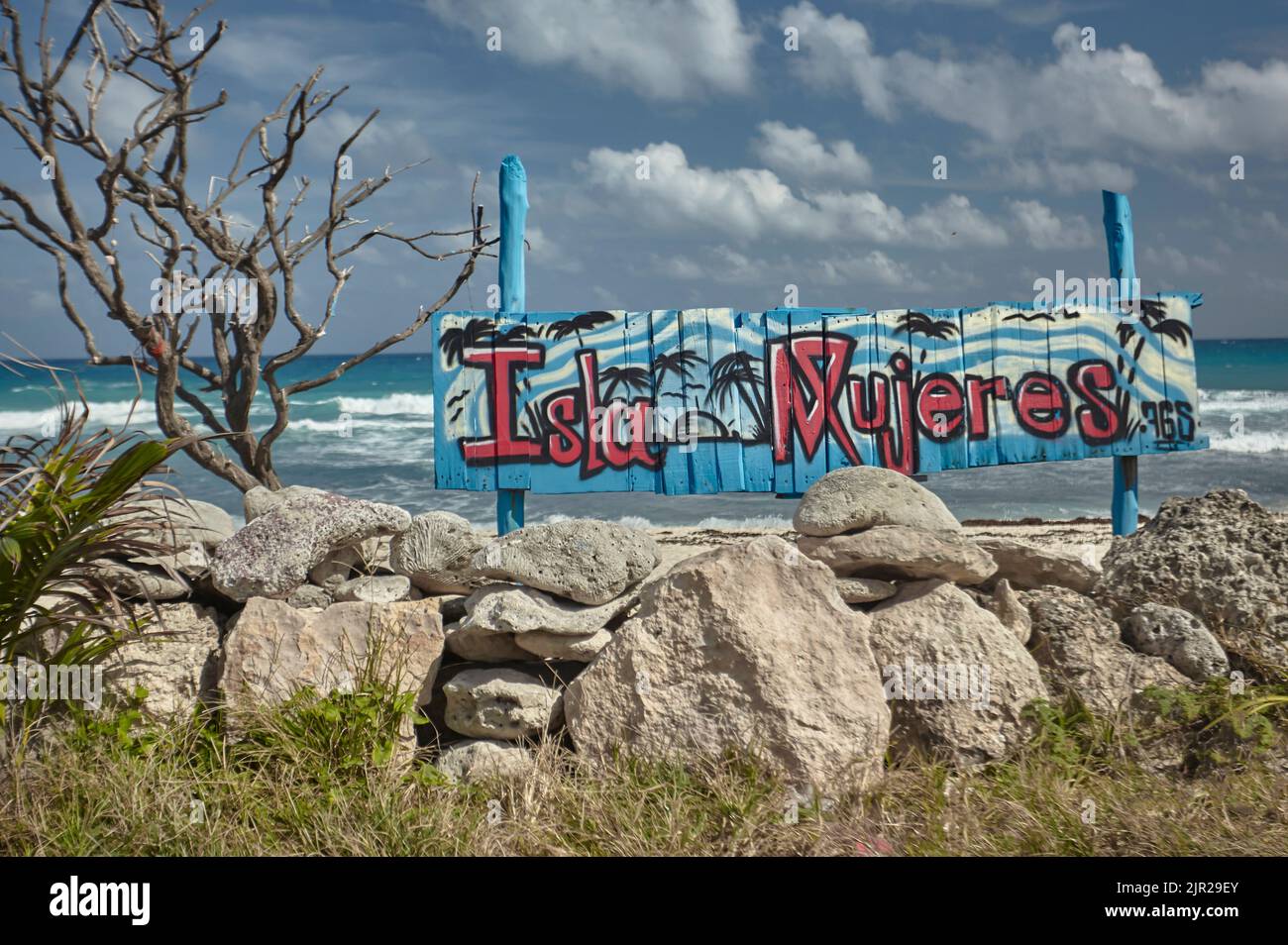 Sign with the colorful writing "Isla Mujeres" immersed in a typical ...