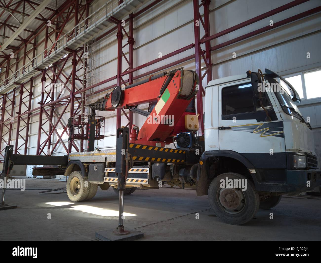 Telehandler inside of hangar Stock Photo - Alamy