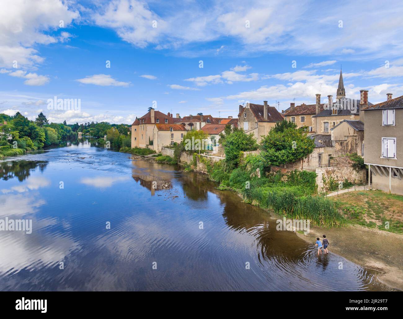 View downstream (with boys paddling) from road bridge above the river ...