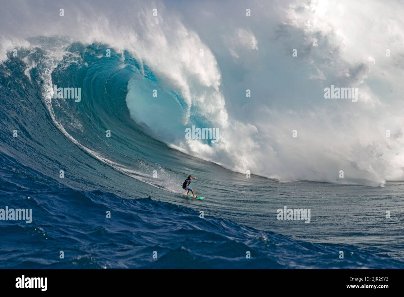 A tow-in surfer drops to the curl of Hawaii's big surf at Peahi (Jaws ...