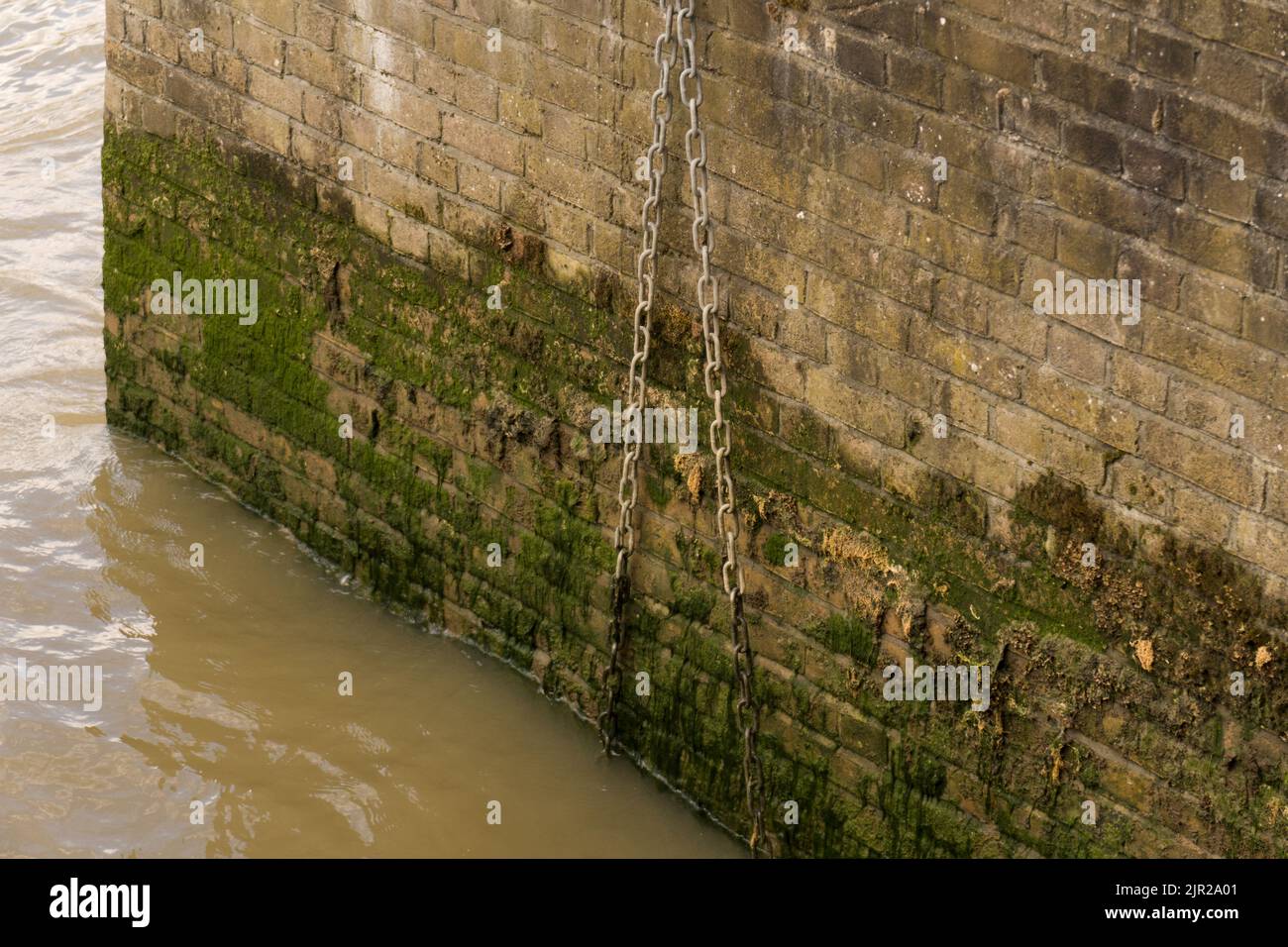 Detail of a brick-built harbor wall on the Thames River waterfront in ...