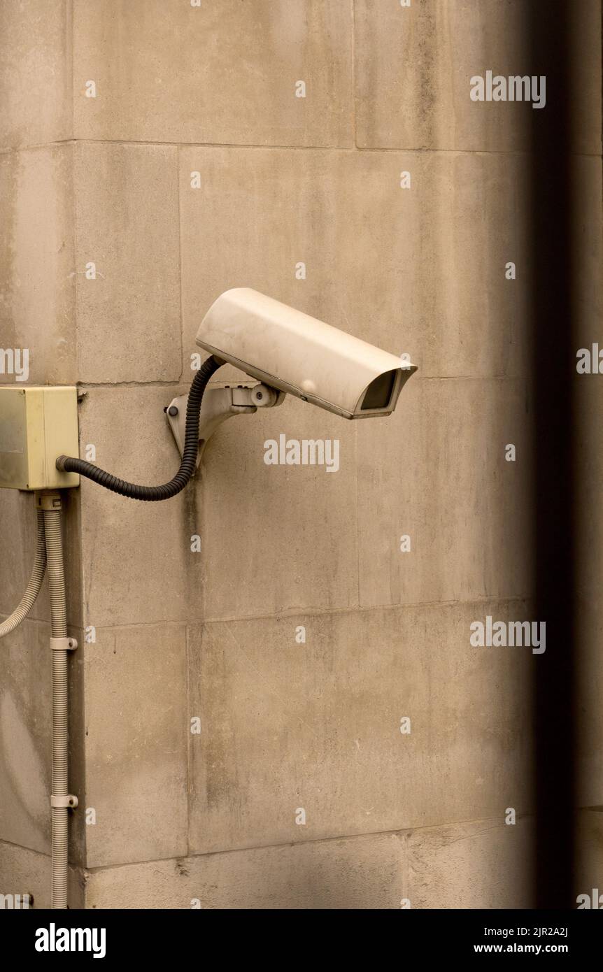 Close up of white surveillance camera mounted on facade ccd video ...