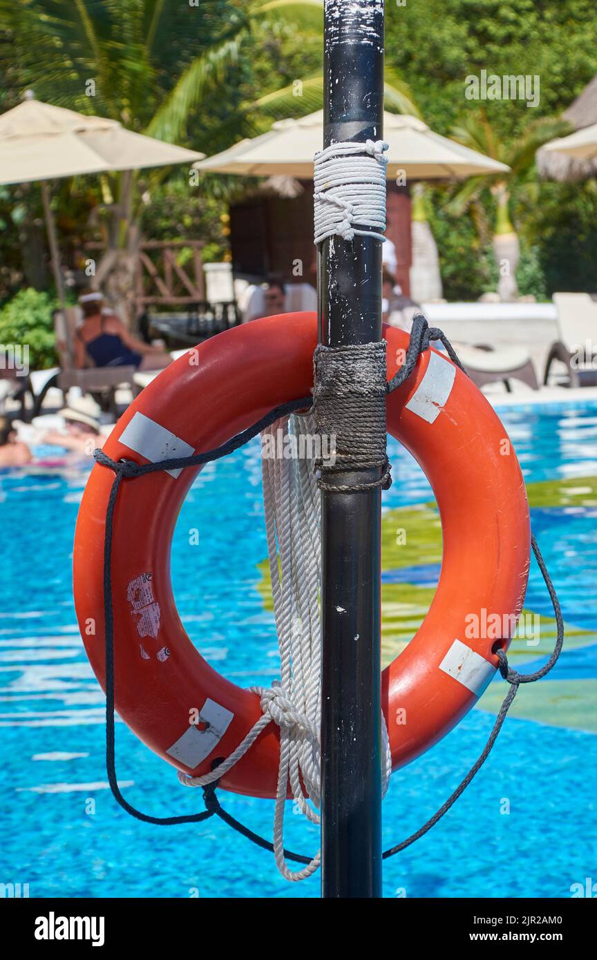 Orange life buoy attached to a pole: safety object in case of need ...