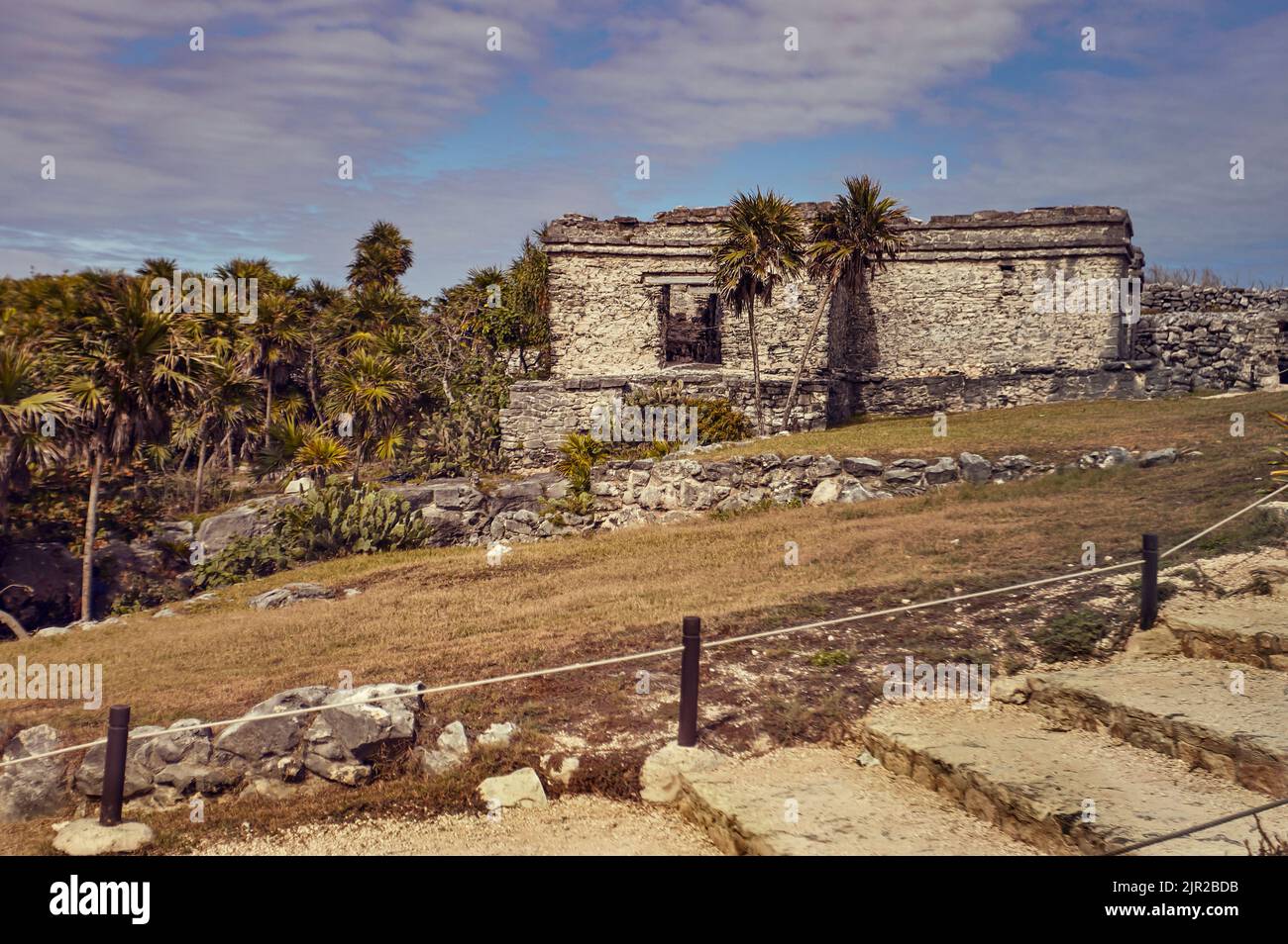 Ruins of Mayan buildings immersed in a green meadow: View of some parts ...