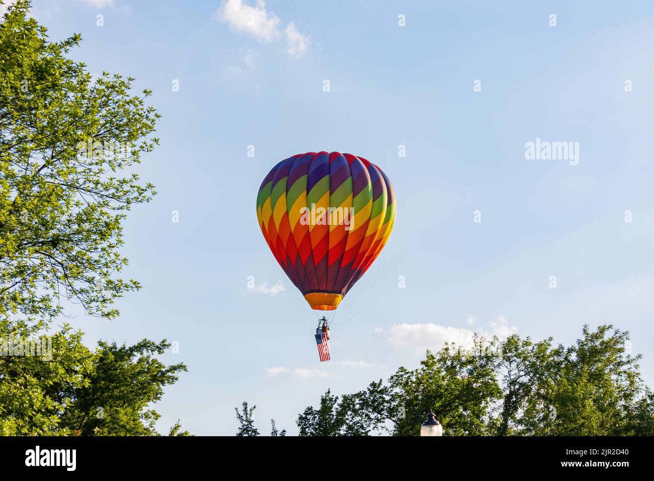 Hot air balloon flying with an American flag in the Firelake Fireflight ...