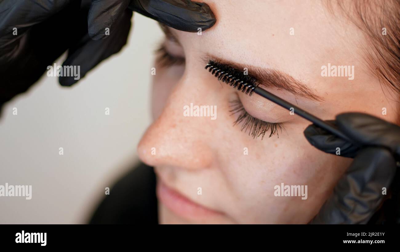 beauty saloon. close-up, hands of the cosmetician in black rubber ...