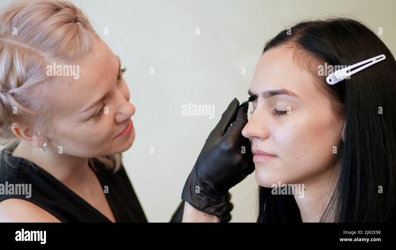 beauty saloon. the cosmetician in black rubber gloves keep a special ...