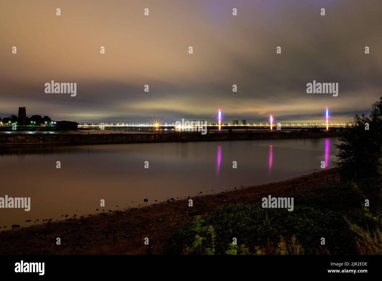 The Mersey Gateway Bridge at night spanning the River Mersey at Runcorn ...