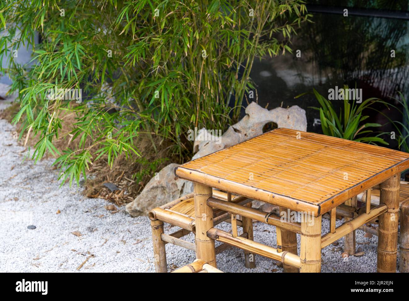 Bamboo table and chairs in Japanese garden Stock Photo - Alamy