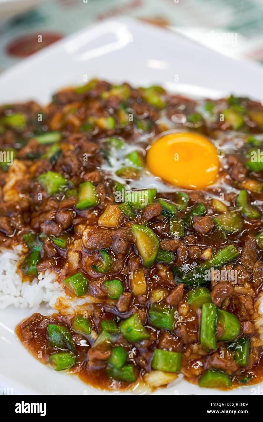 A plate of delicious and tempting nest egg minced beef rice in a Hong ...