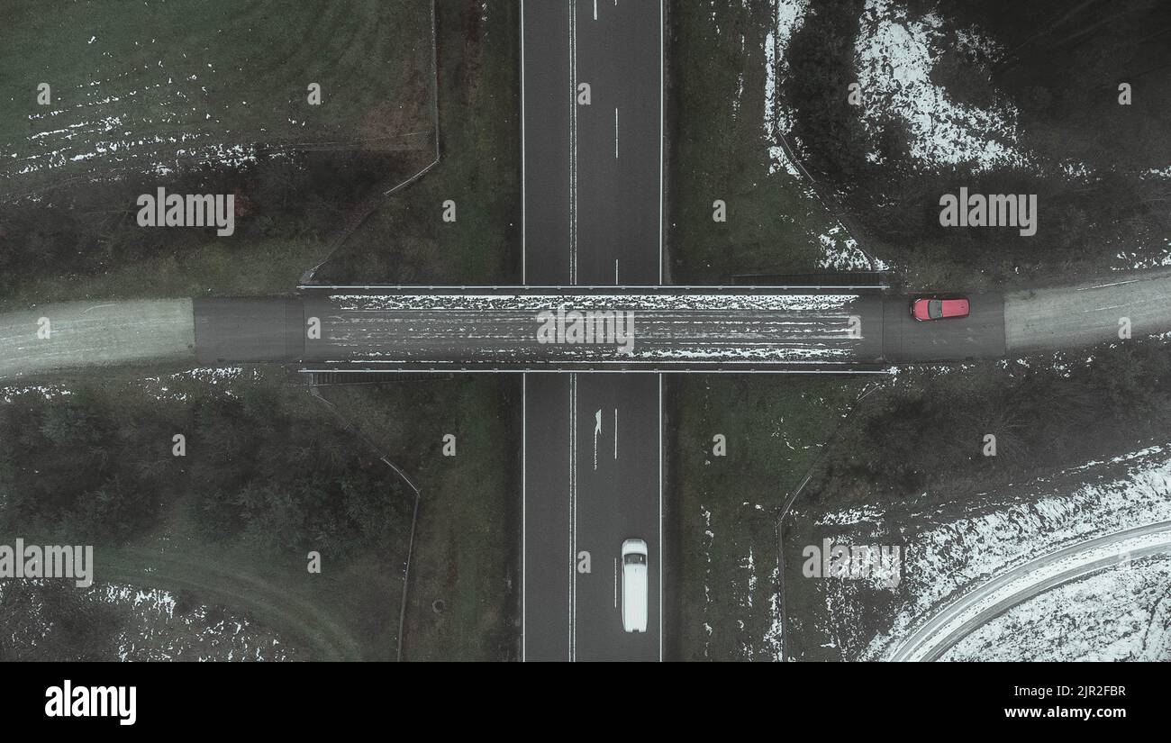 An aerial top view of road under bridge in a misty day Stock Photo - Alamy