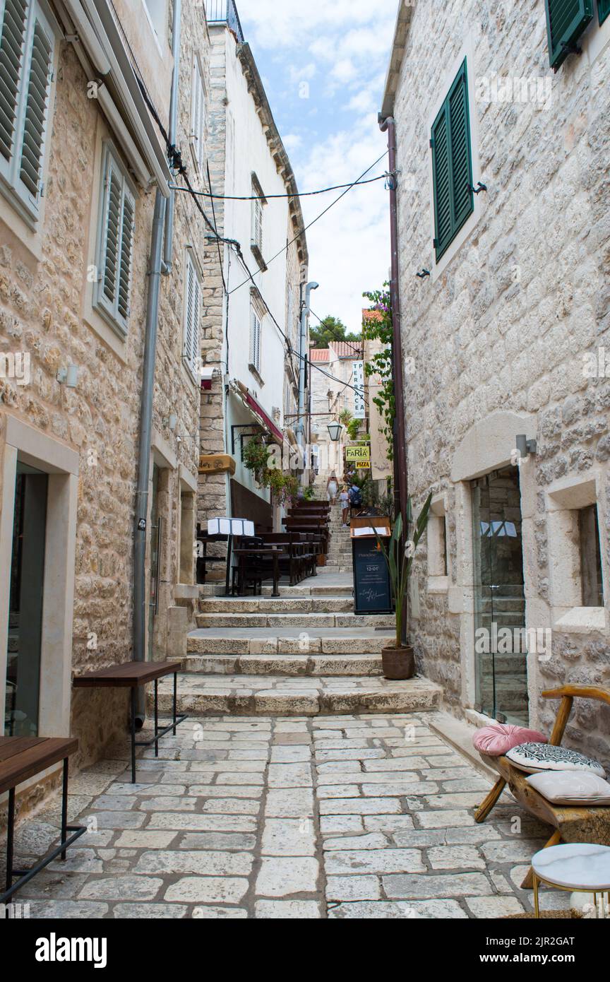 Hvar, Croatia - 17 June 2022: Narrow street with old stone houses ...