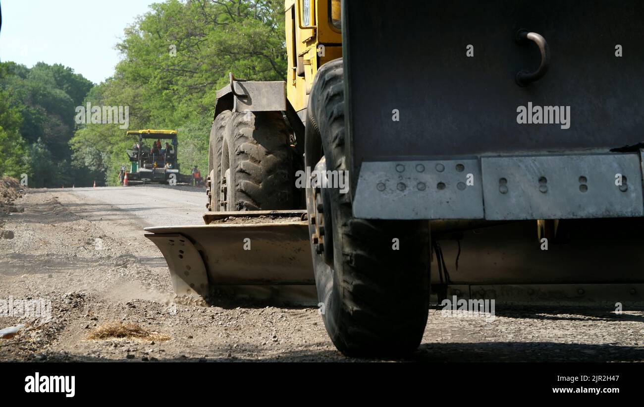 Road construction works, repair of a highway, The tractor is leveling ...