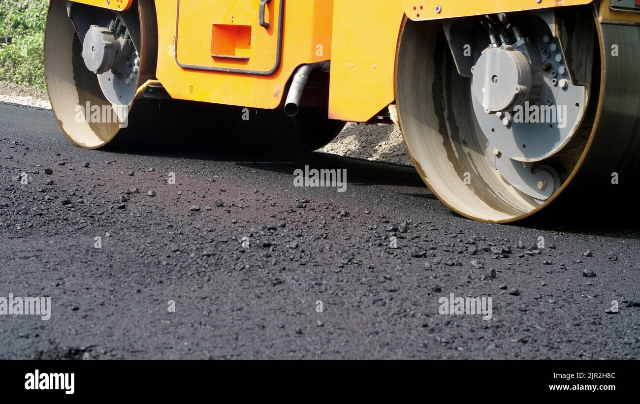 close-up, Road construction works with roller compactor machine and ...