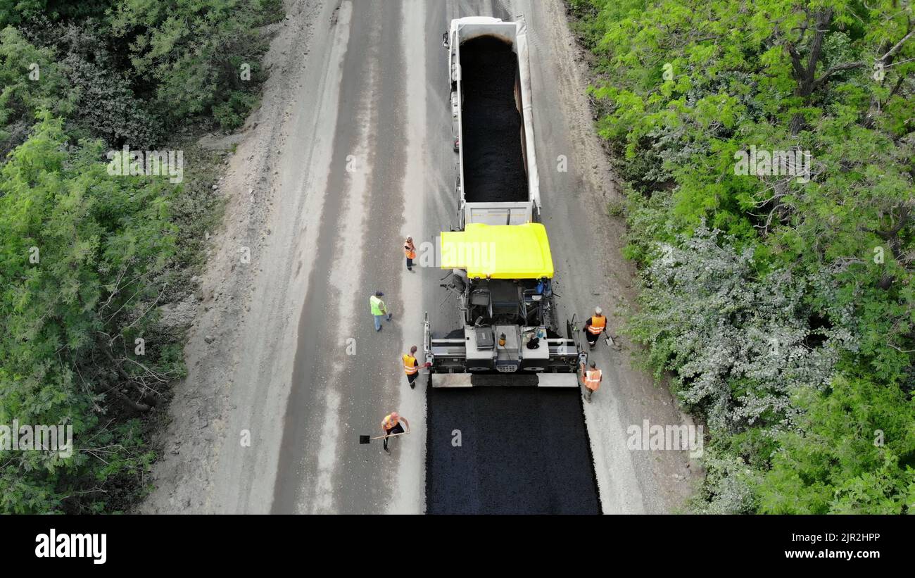 Aerial view on repair of a highway, the process of laying a new asphalt ...