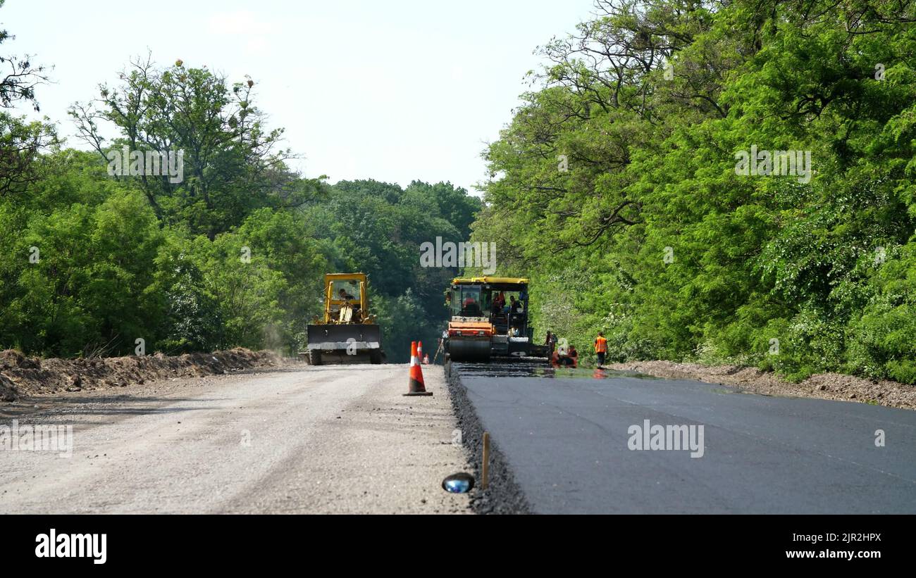 repair of a highway, roller compactor machine and asphalt finisher ...