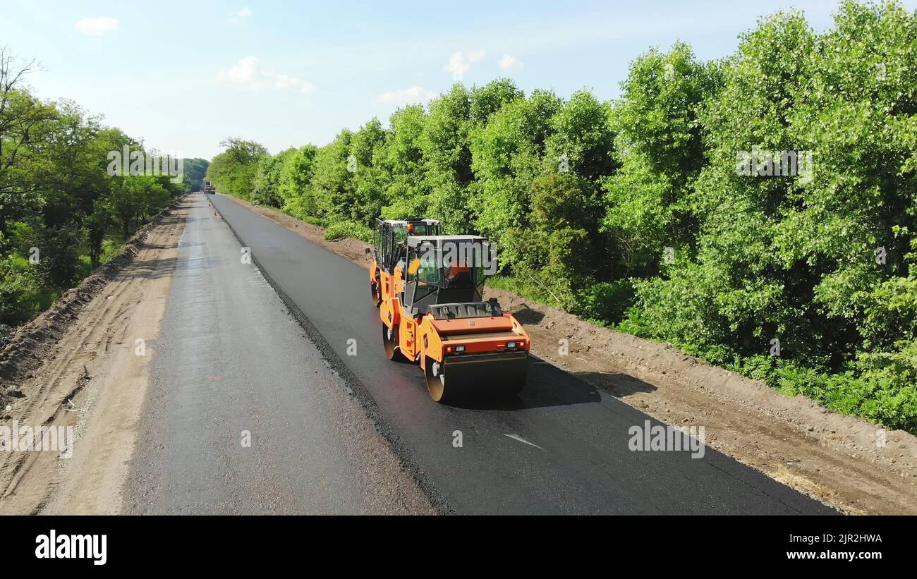 Aerial view on repair of a highway, the process of laying a new asphalt ...