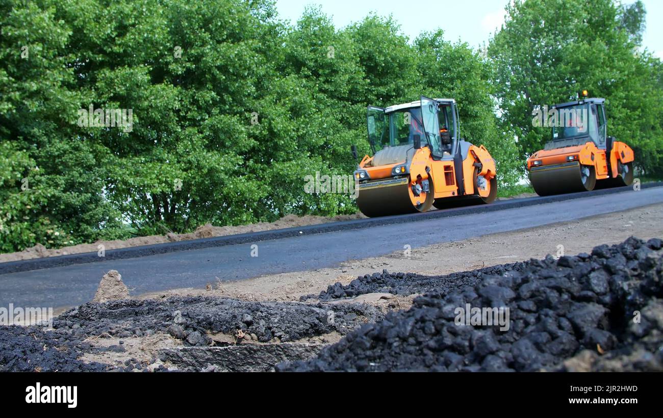 repair of a highway, roller compactor machine and asphalt finisher ...