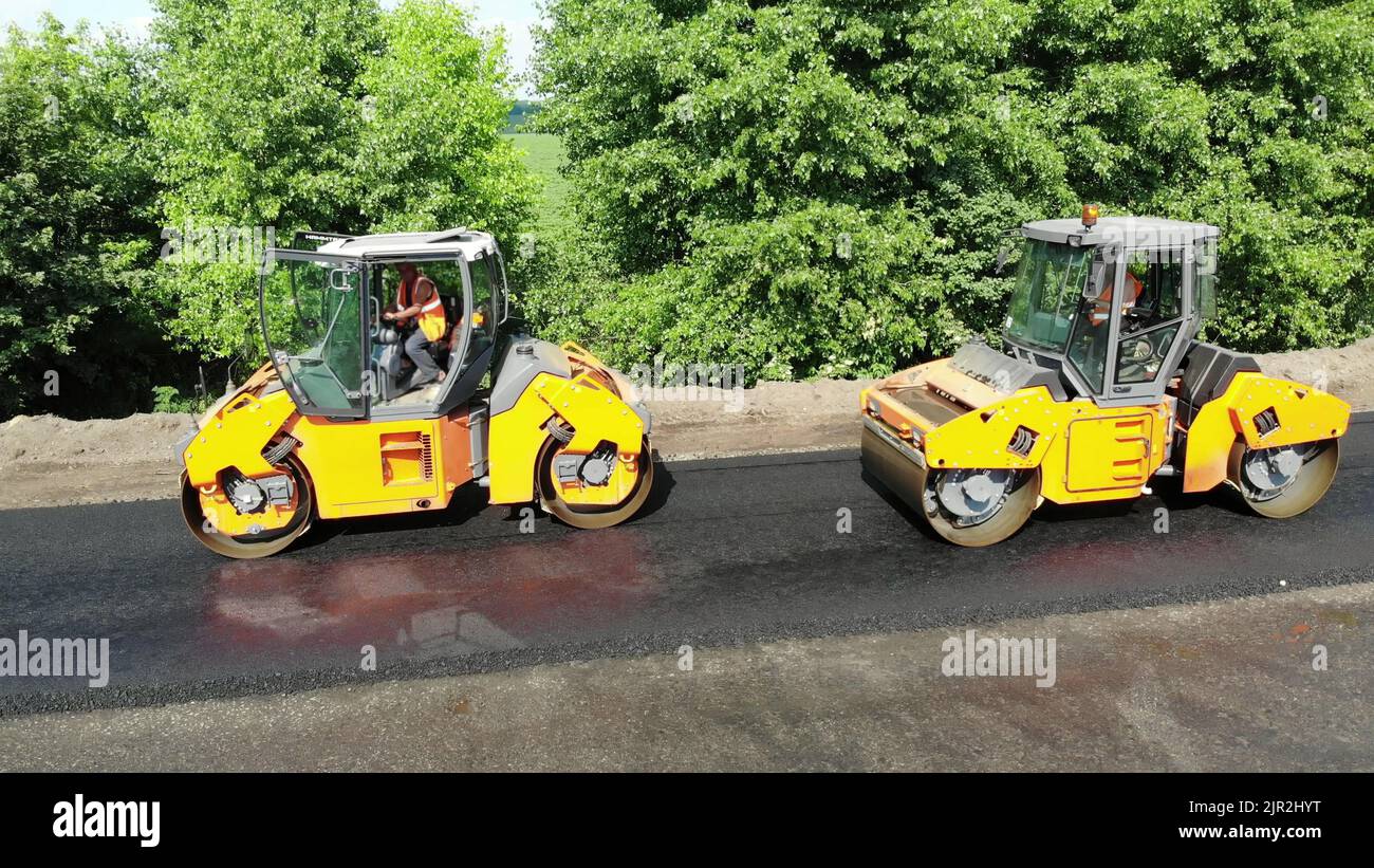 Aerial view on repair of a highway, the process of laying a new asphalt ...