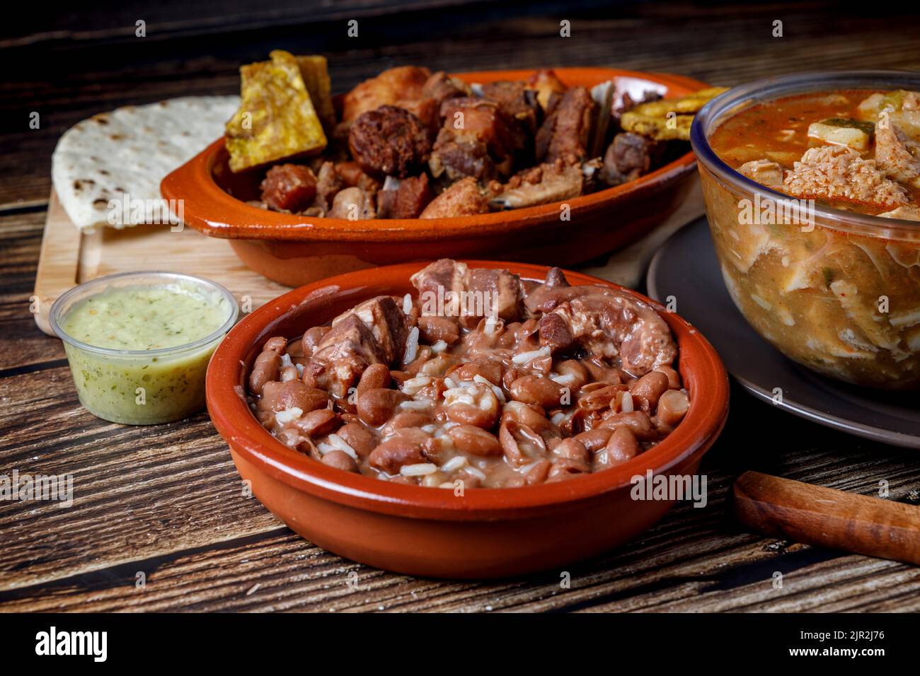Variety of traditional Colombian food with beans, picada, tripe soup ...